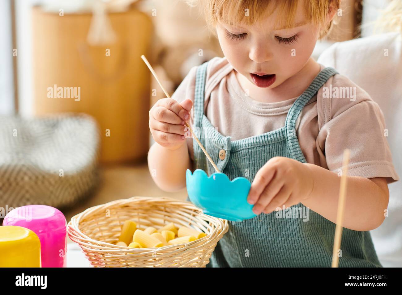 A young girl sits peacefully, learning through play at home Stock Photo ...