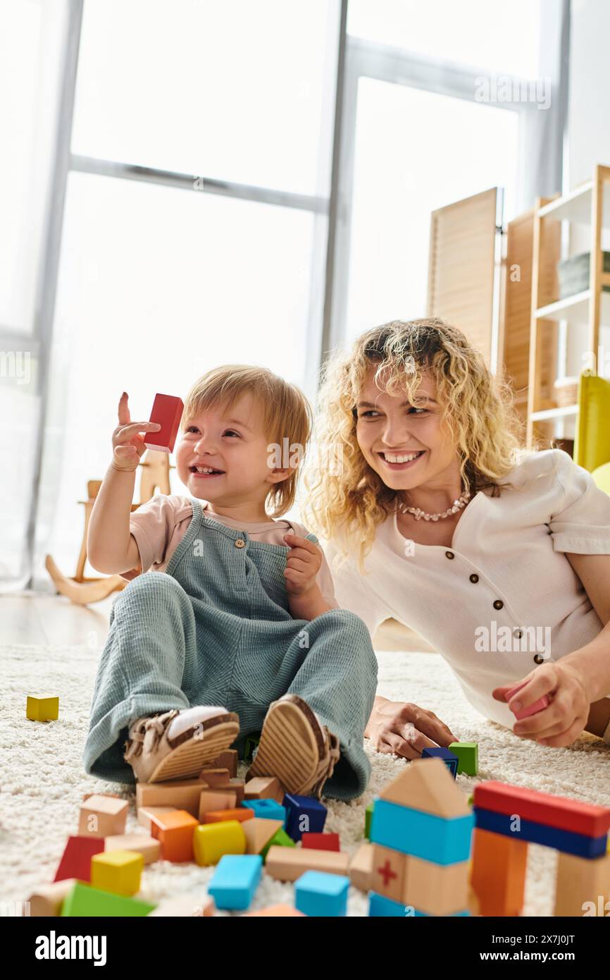 A curly-haired mother and her toddler daughter engage in educational ...