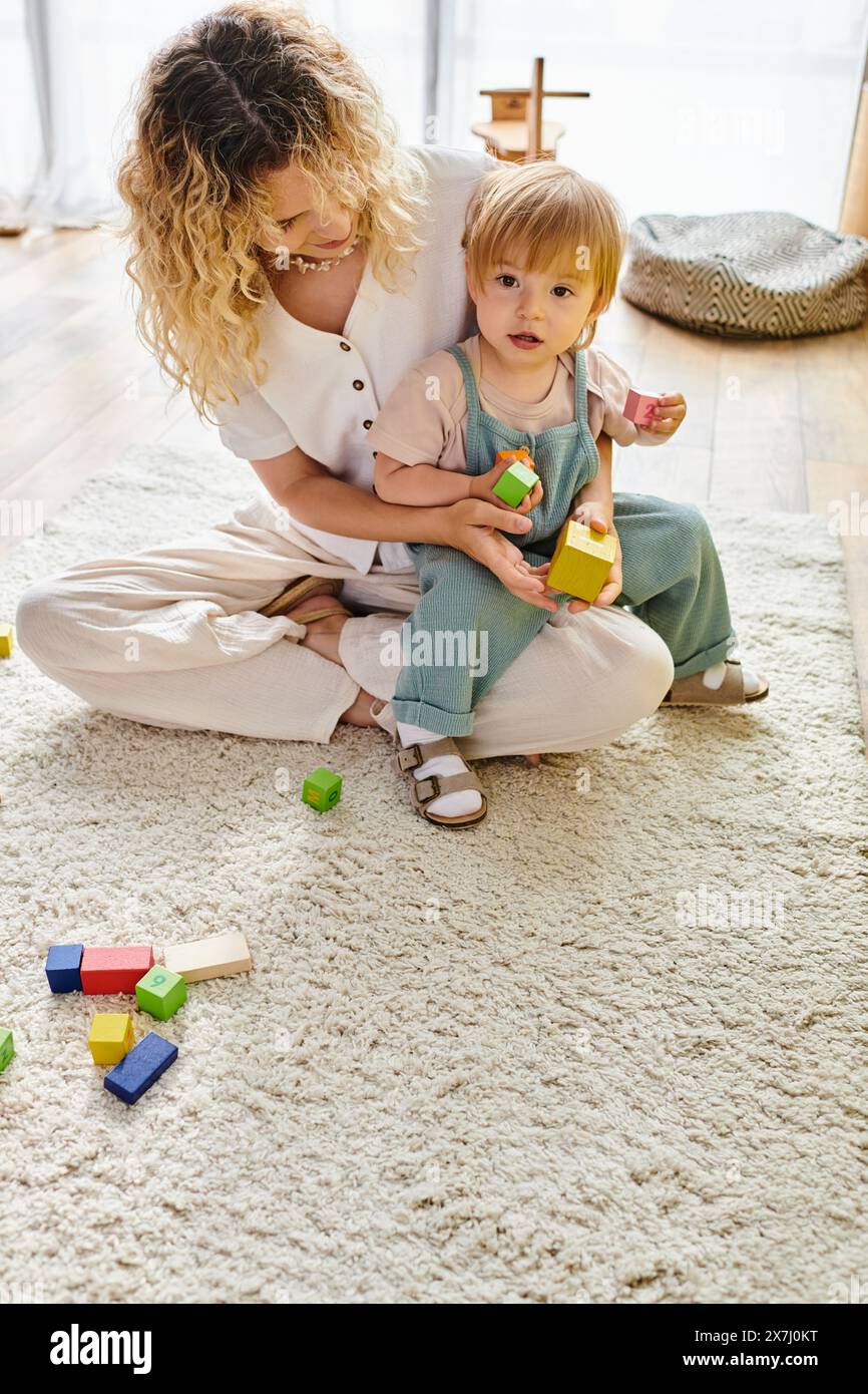 Curly mother and toddler daughter bond over Montessori block play ...