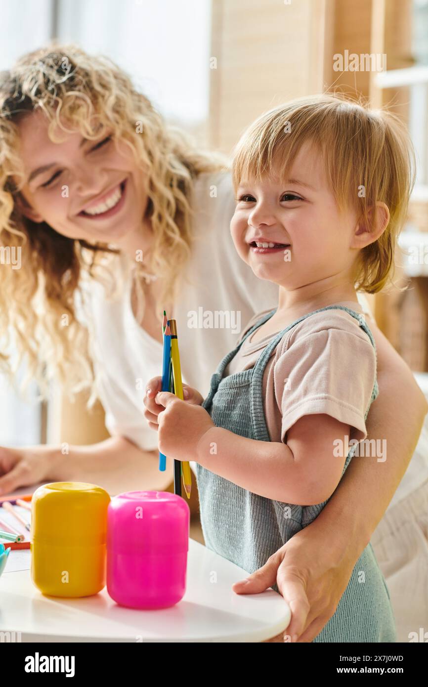 A curly mother and her toddler daughter engage in playful exploration ...