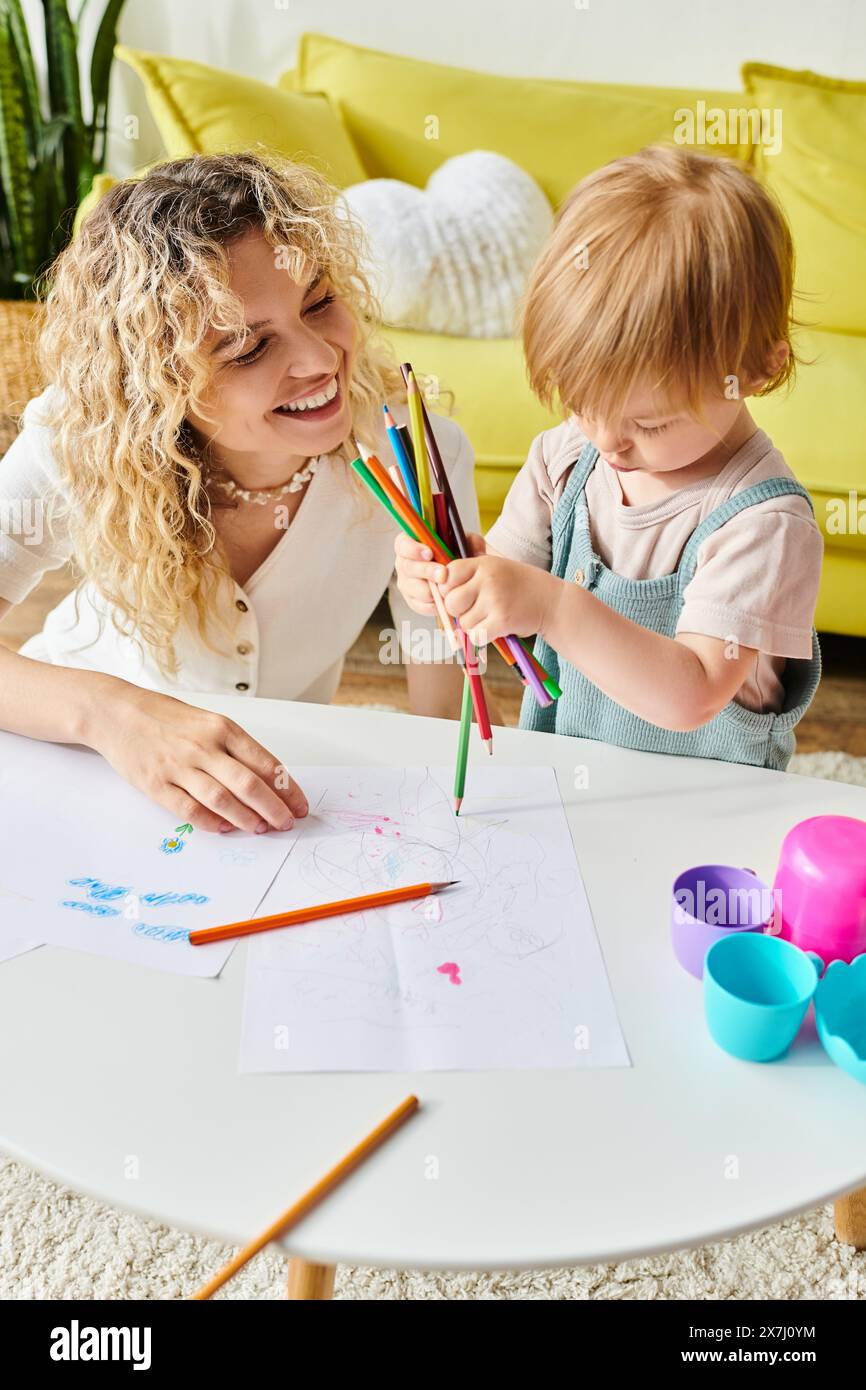 A curly mother and her toddler daughter bonding over crayons using the ...
