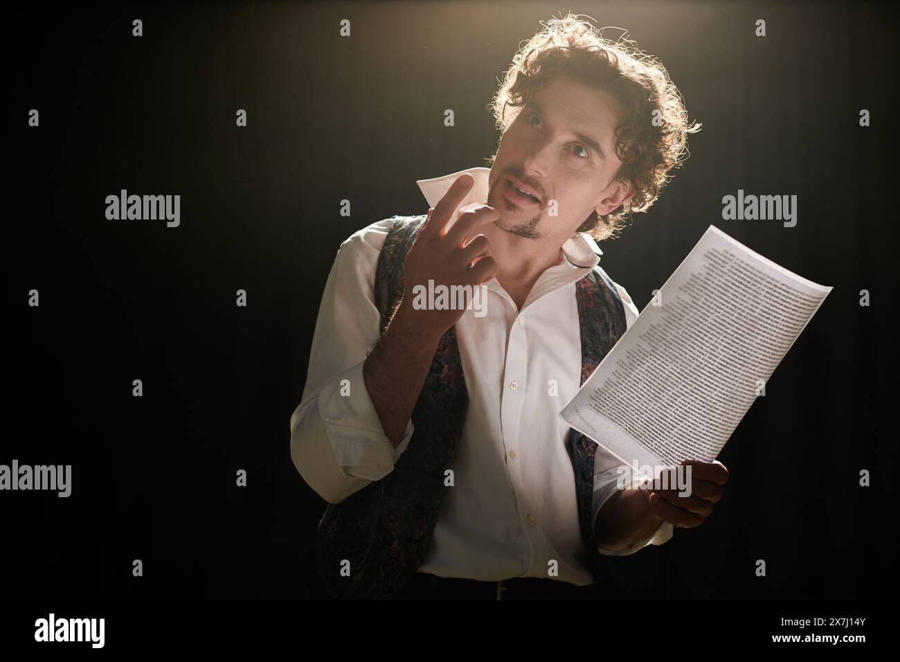 A man engrossed in a script, captivated by its contents Stock Photo - Alamy