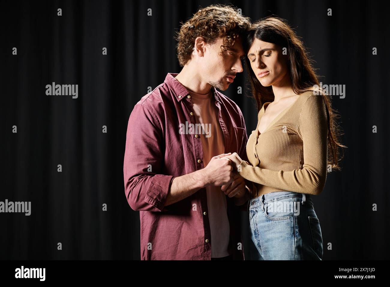 A handsome man and a beautiful woman rehearsing on stage Stock Photo ...