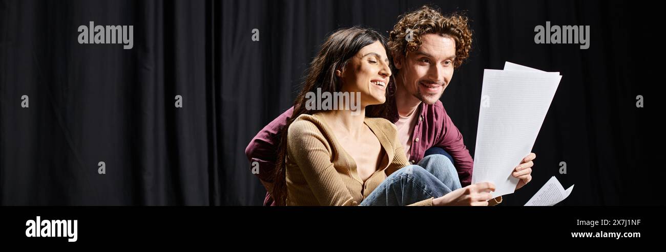 Man and woman on stage, holding scripts Stock Photo - Alamy
