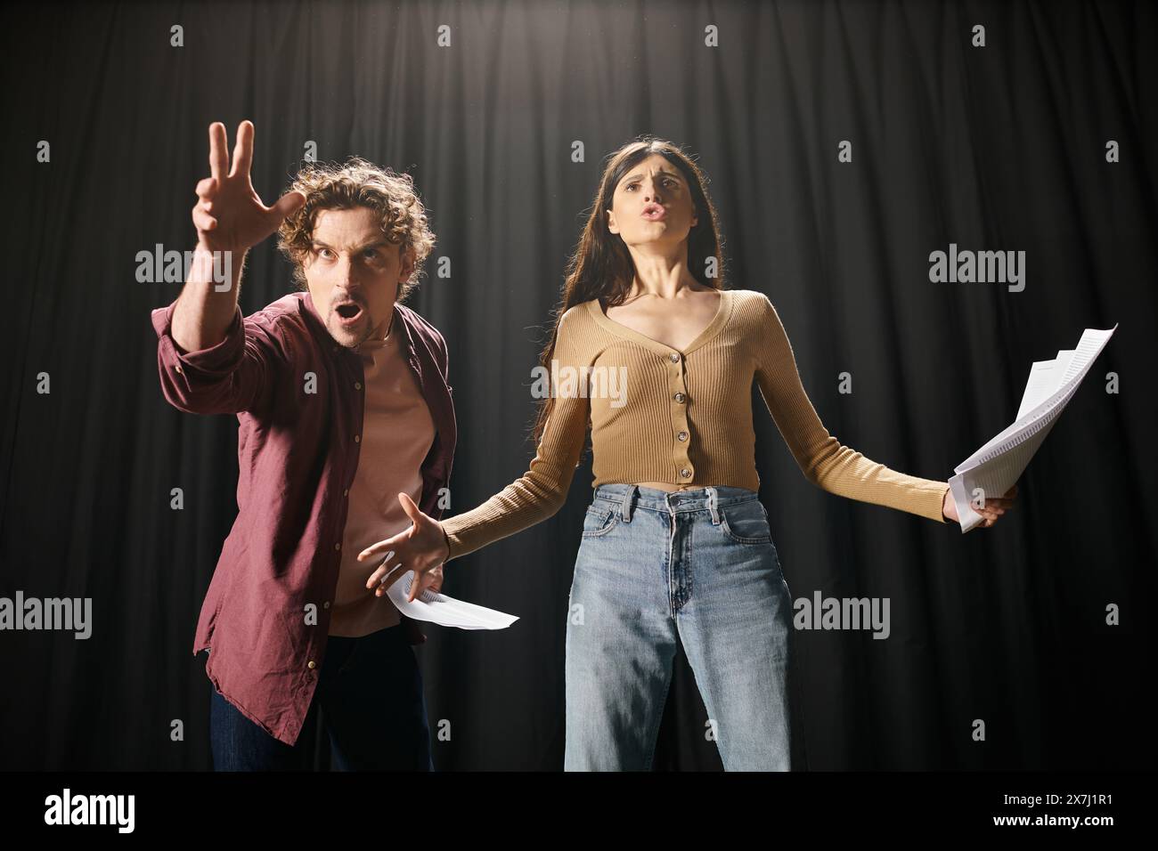 Handsome man and woman stand elegantly together, rehearsing for a ...