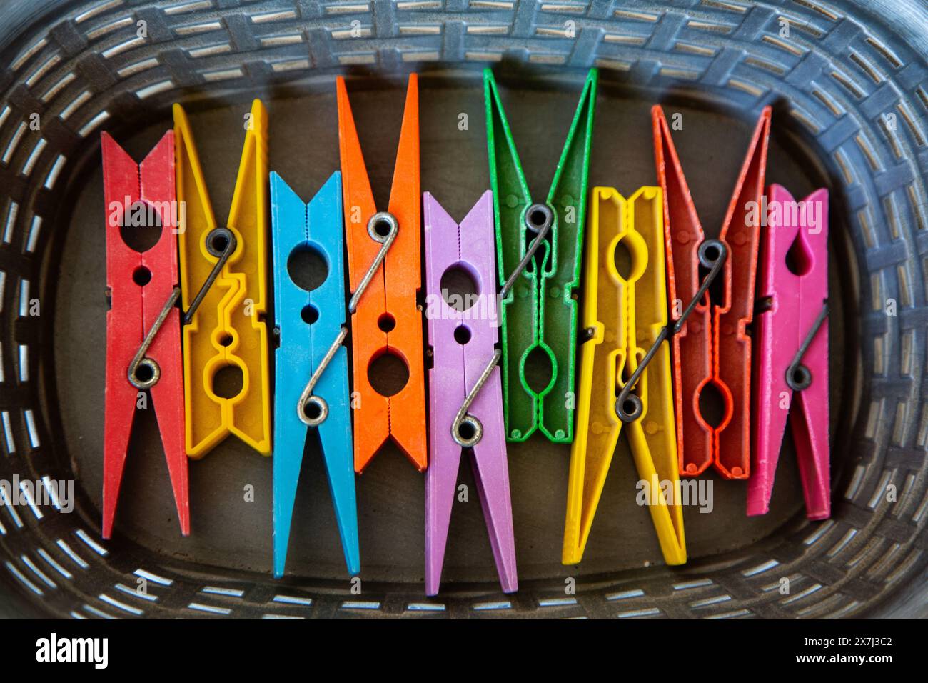 Colorful clothespins spread across a surface Stock Photo - Alamy