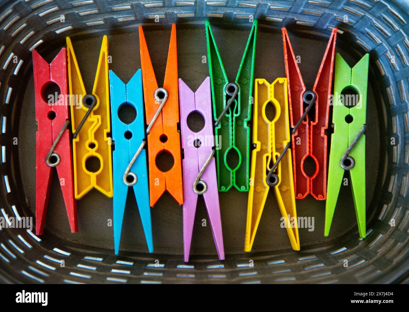 Colorful clothespins spread across a surface Stock Photo - Alamy