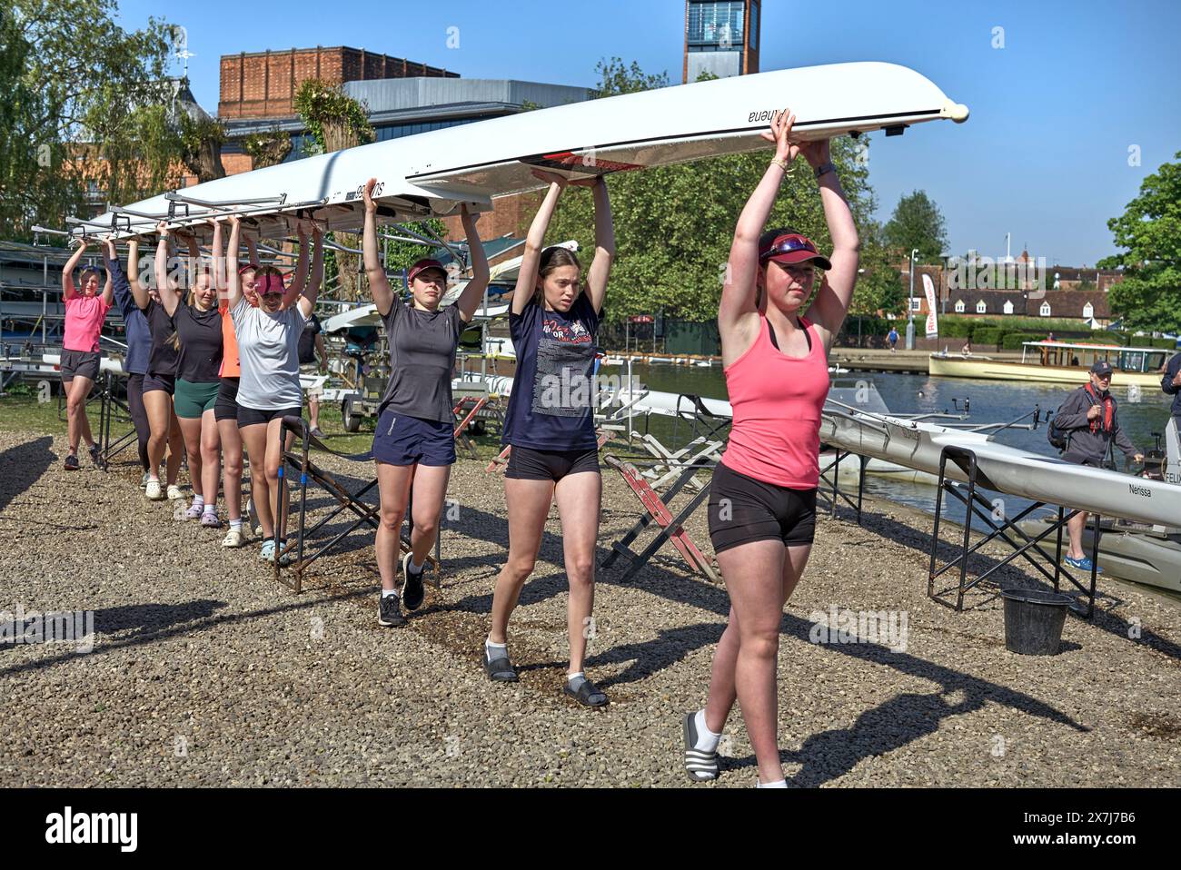 Female rowing crew carrying rowing boat above their heads to launch area. Stratford upon Avon ...