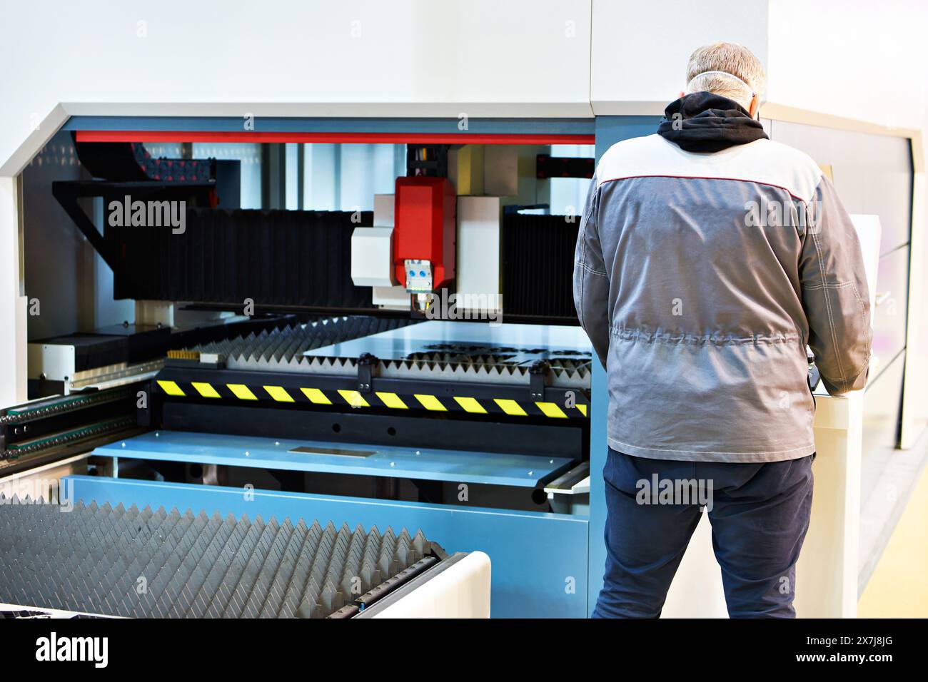 Man works on a laser cutting machine Stock Photo - Alamy