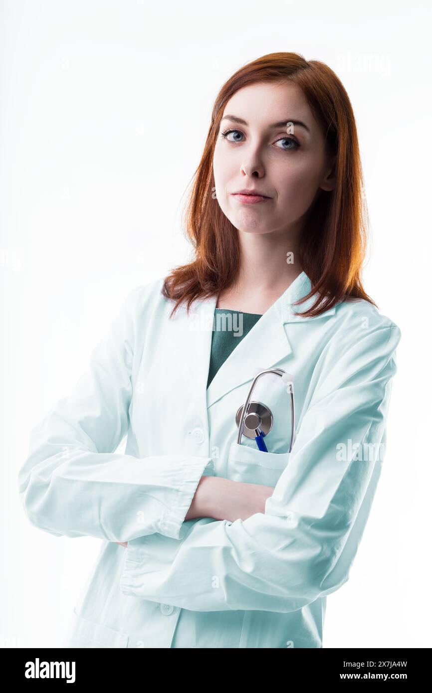 Young woman with auburn hair wears a white lab coat and stethoscope ...