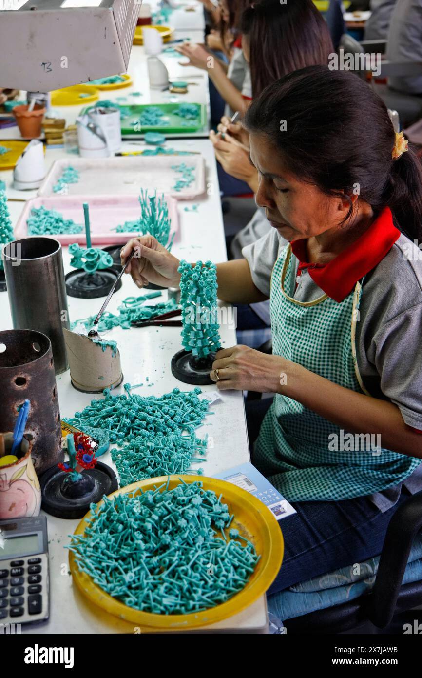 Thailand, Bangkok, a Thai woman carving a wax sculpture in a factory ...