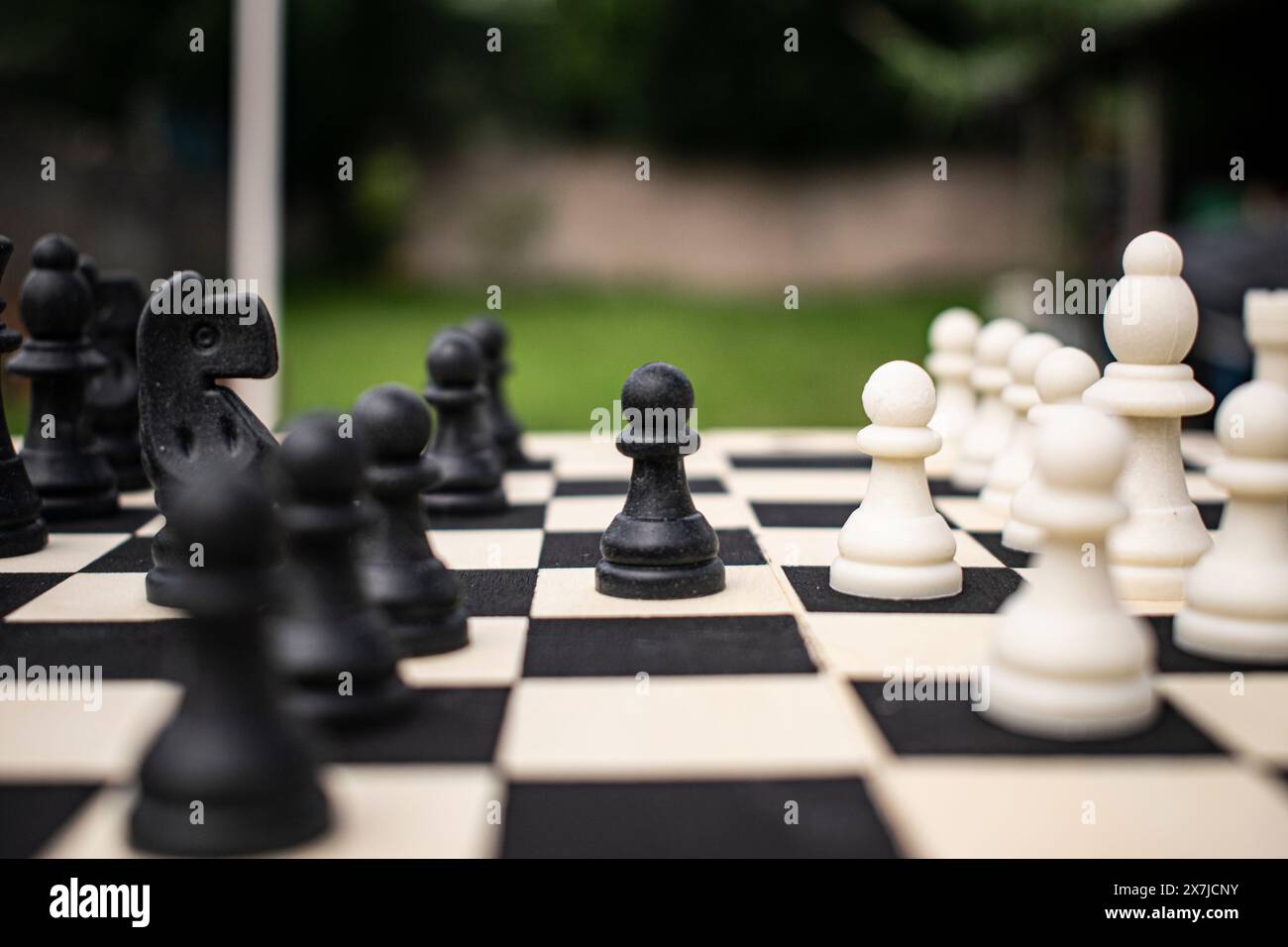 Rustic chess set, the board is made of wood and the pieces are made of ...