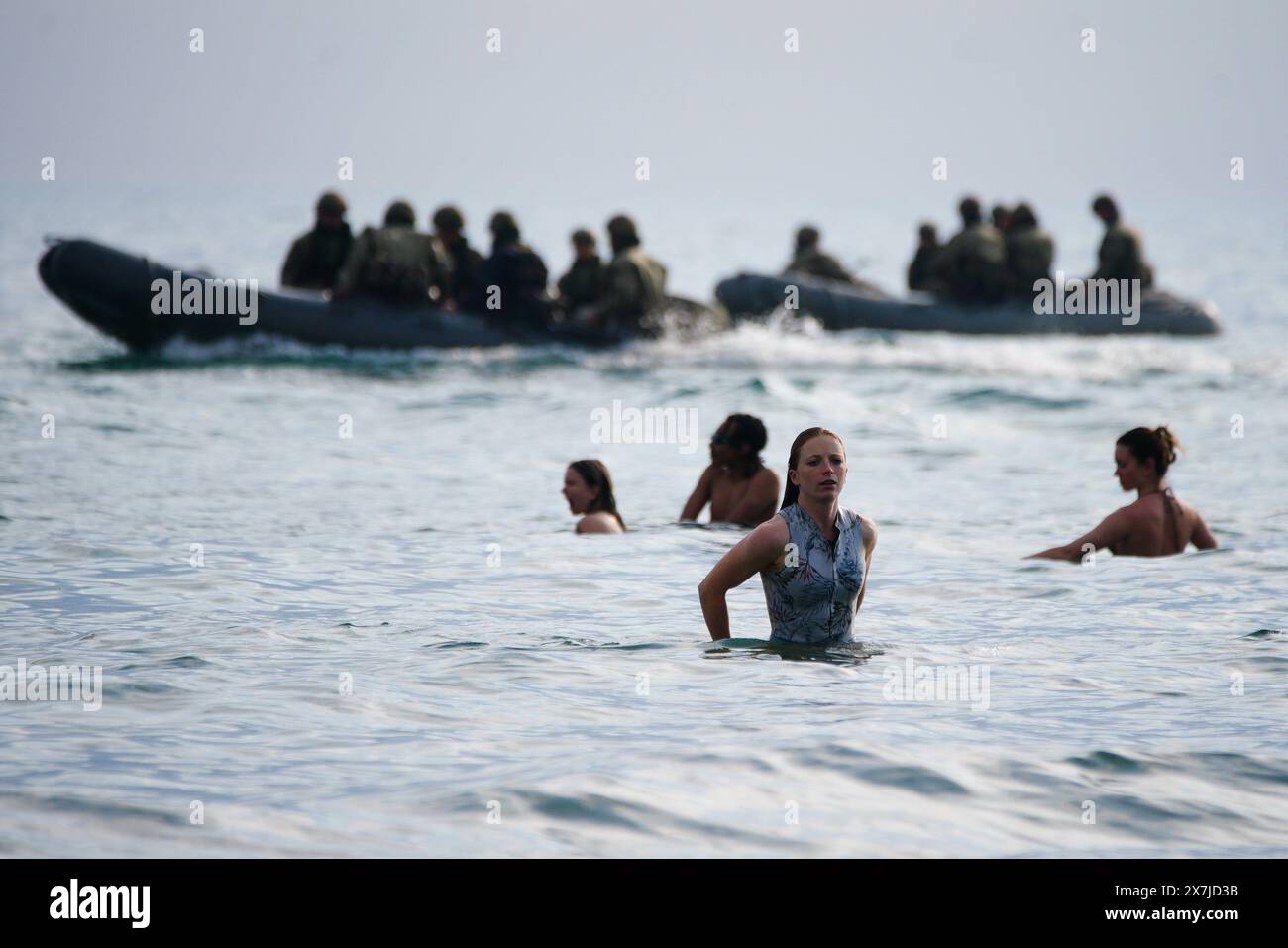 Swimmers watch as memebers of Armed Forces personnel from 47 Commando ...