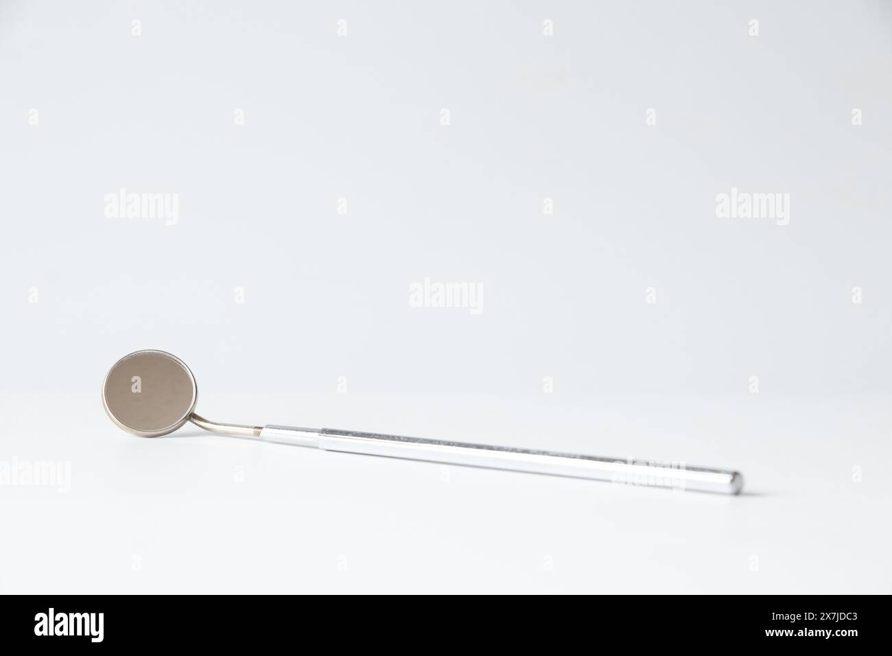 Dental mirror on white background close up Stock Photo - Alamy