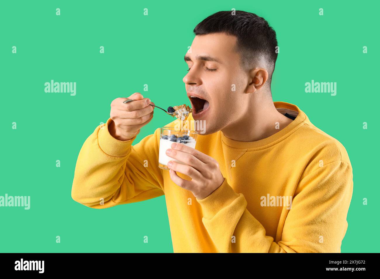 Happy man eating yogurt hi-res stock photography and images - Alamy