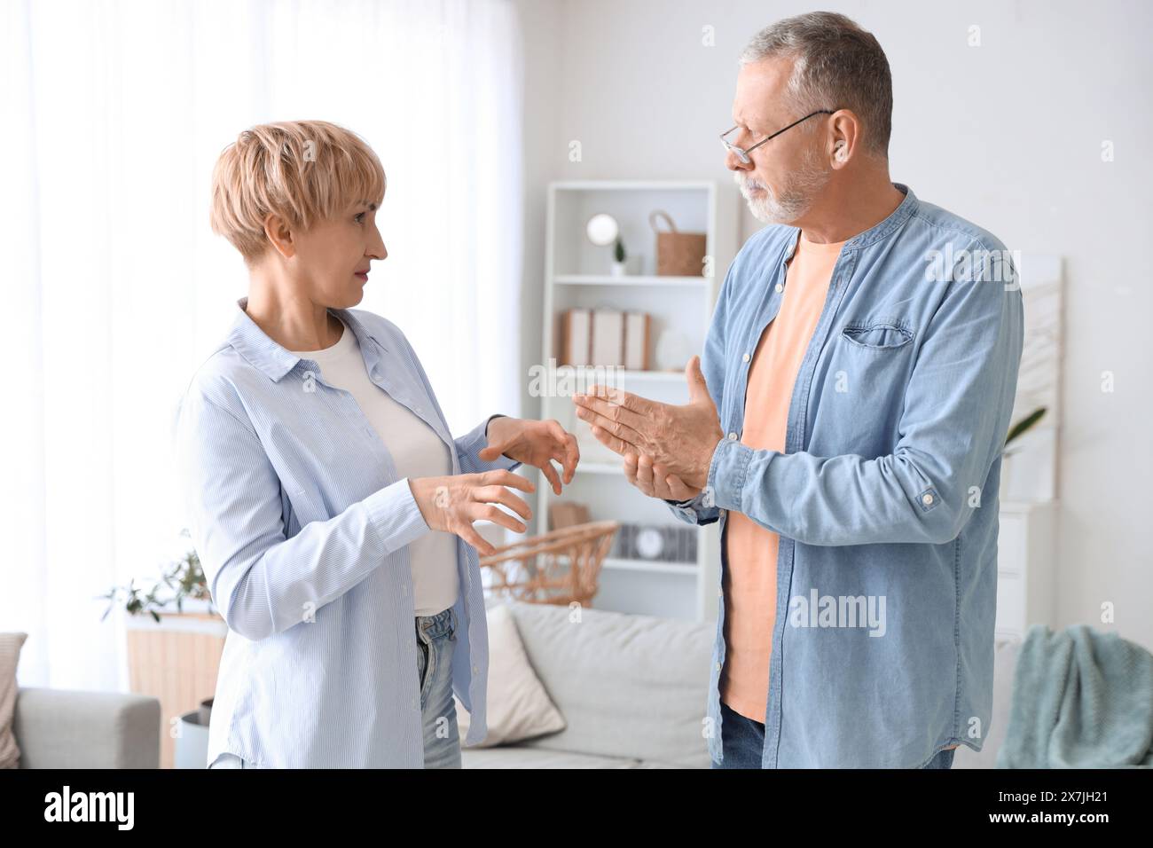 Mature deaf mute couple quarrelling in sign language at home Stock ...