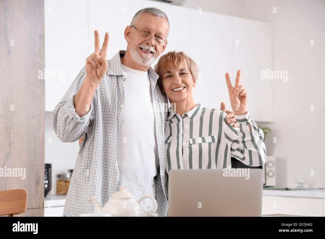 Happy mature deaf mute couple using sign language in kitchen Stock ...