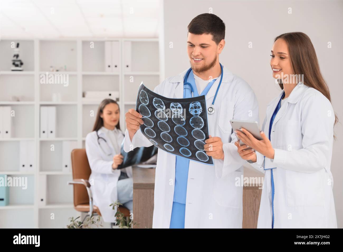 Smiling doctors studying MRI scan at hospital Stock Photo - Alamy
