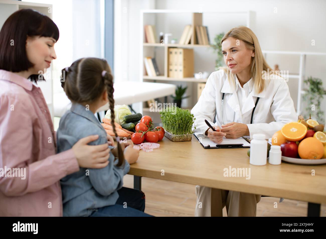 Female dietitian prepares course of healthy nutrition for small child ...