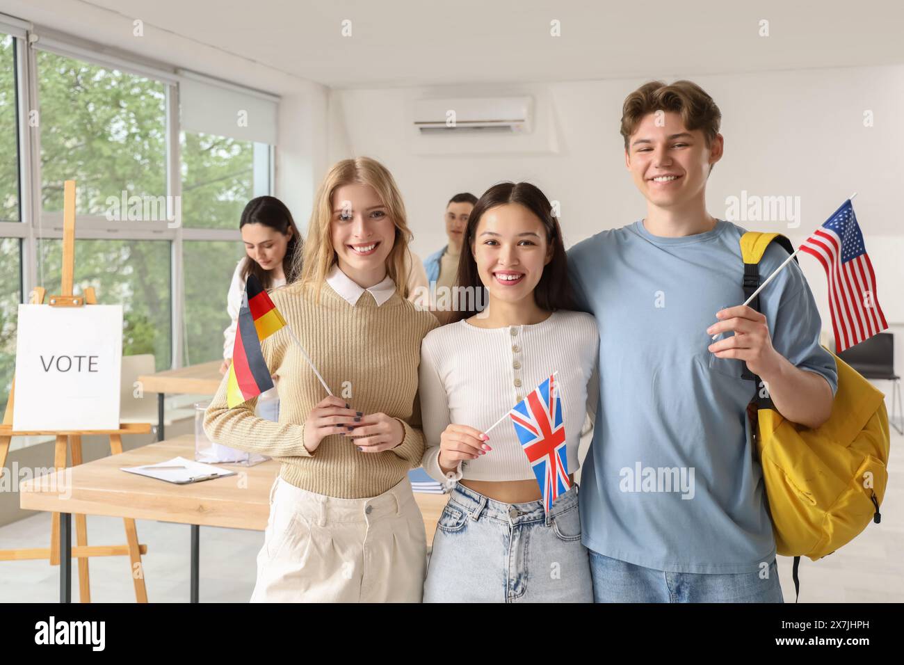 Voting young people with different flags at polling station Stock Photo ...