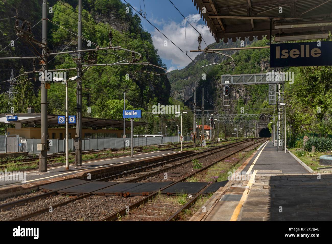 Trains and station with peron in sunny spring hot morning in Iselle ...