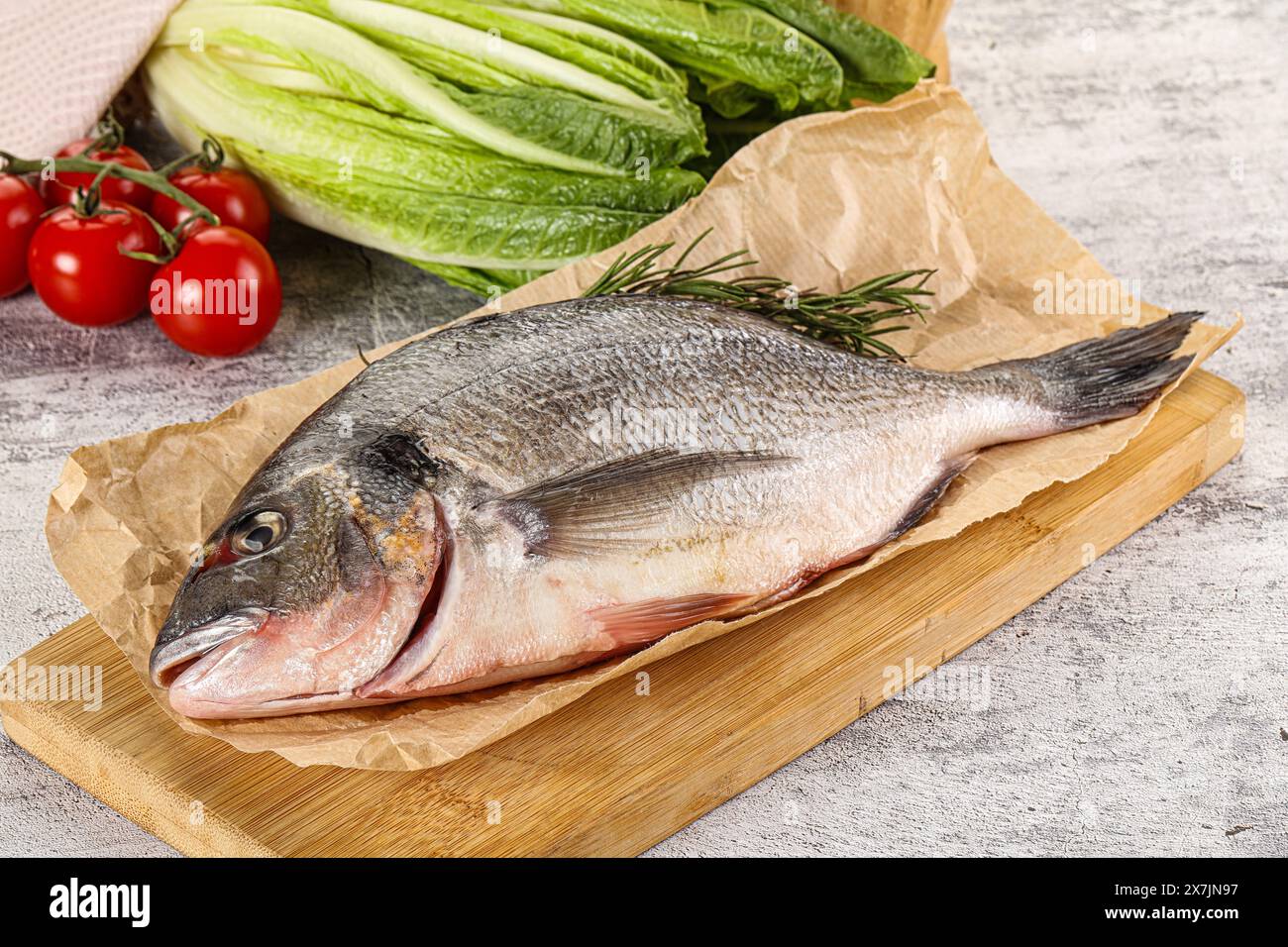Raw dorada fish served rosemary for cooking Stock Photo - Alamy