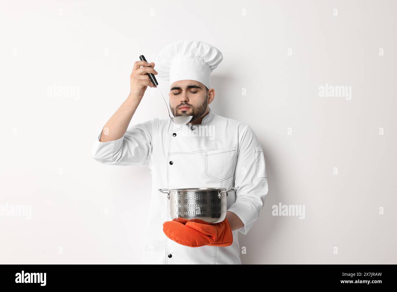 Professional chef smelling something on white background Stock Photo ...