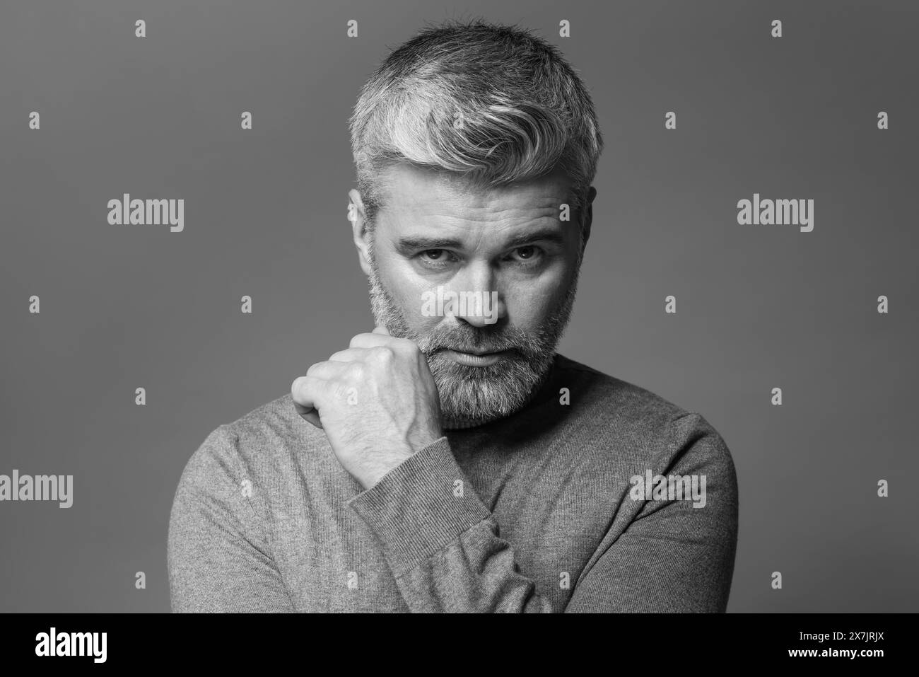 Portrait of handsome man on grey background. Black and white effect ...