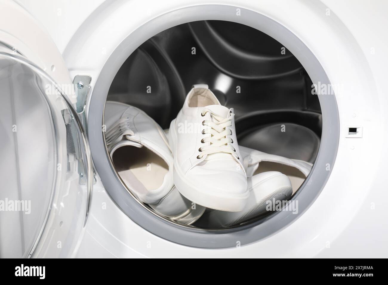 Stylish clean sneakers inside modern washing machine Stock Photo - Alamy