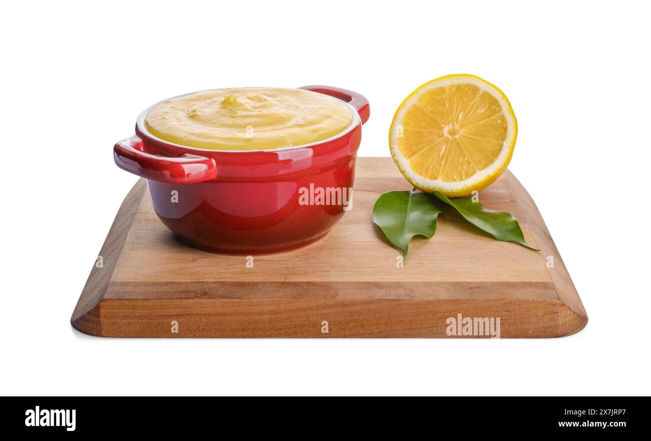 Delicious lemon curd in bowl, fresh citrus fruit and green leaves ...