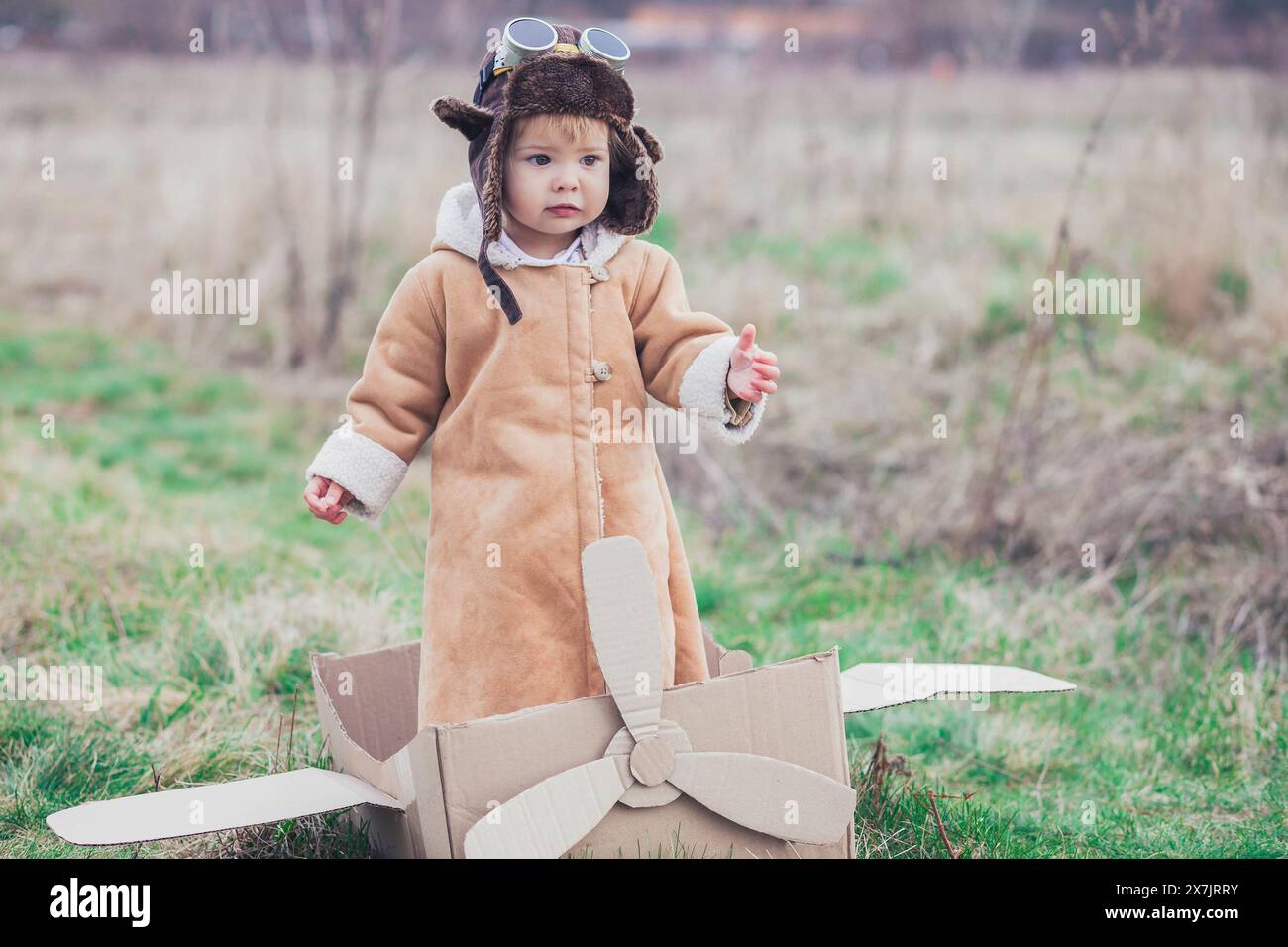 Charming baby in aviator's clothes on the cardboard plane Stock Photo ...