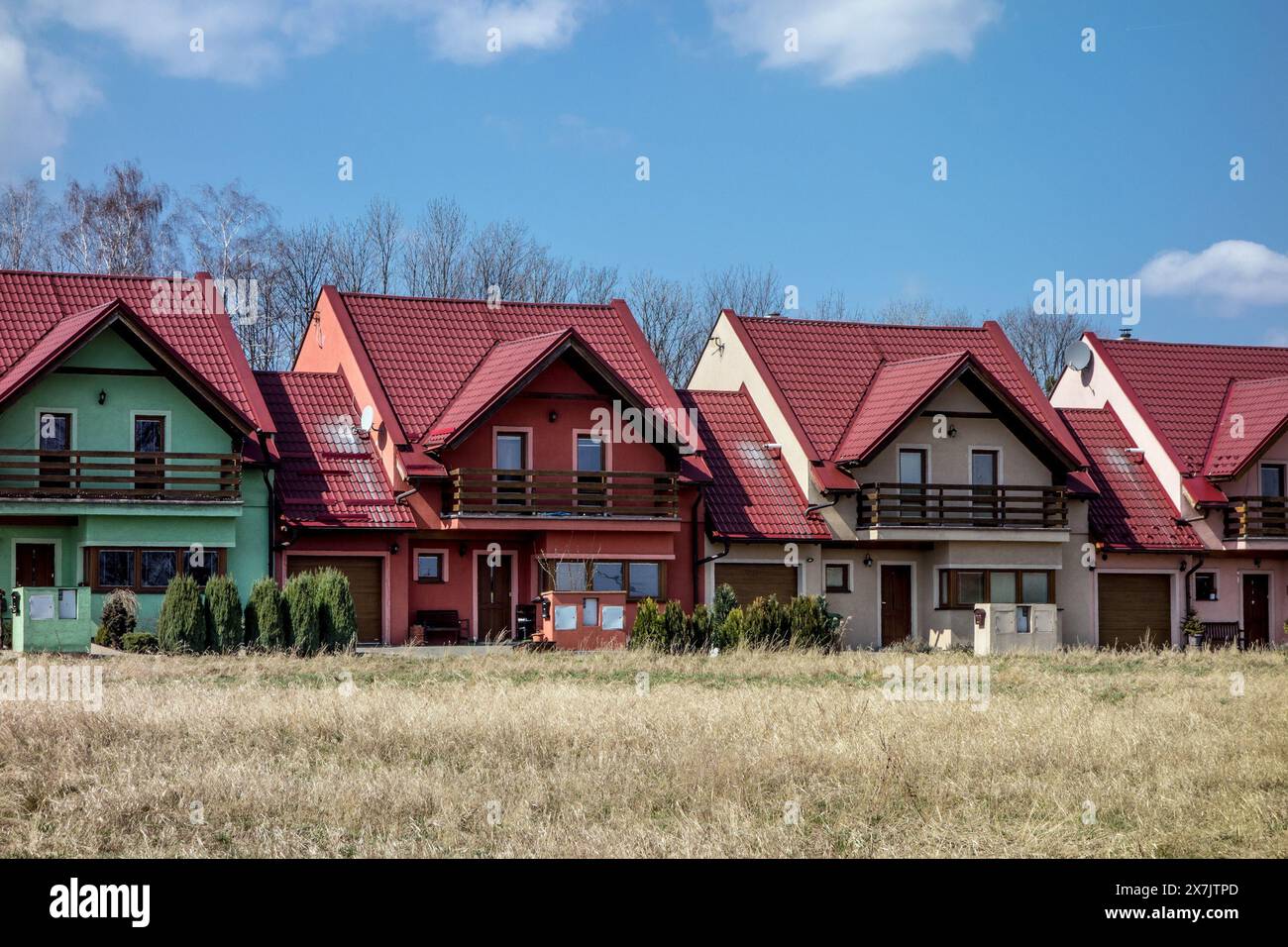 Block of terraced houses with uniform design but different colours ...