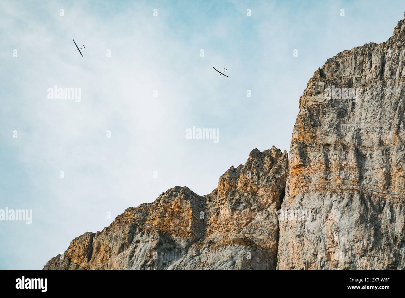 Two gliders soaring above the rocky cliffs of the Churfirsten mountain ...