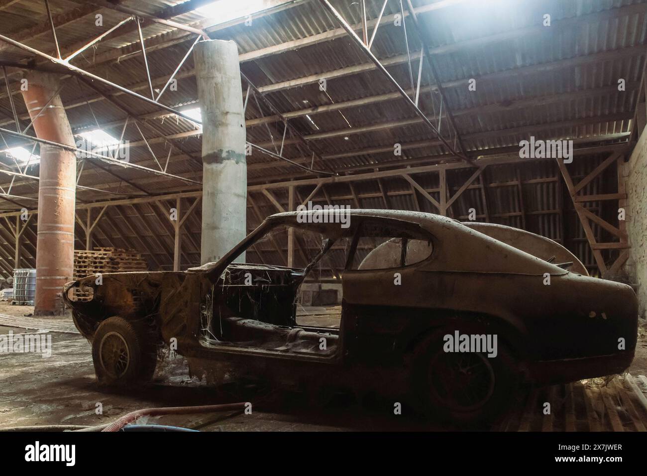 Old disassembled car in an abandoned factory Stock Photo - Alamy