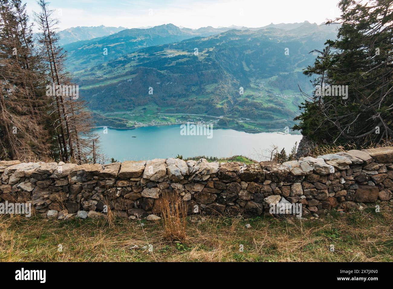 A stone wall marks the edge of a hiking trail in the Churfirsten ...