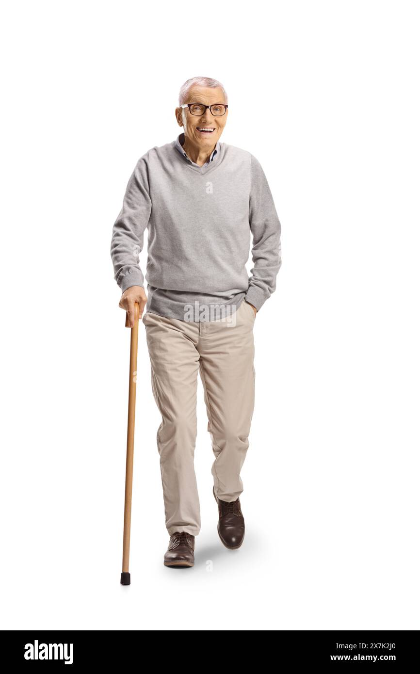 Elderly man with a cane walking towards camera isolated on white ...