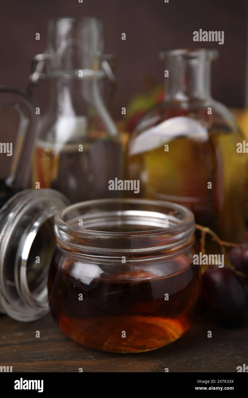 Different types of vinegar on wooden table Stock Photo - Alamy
