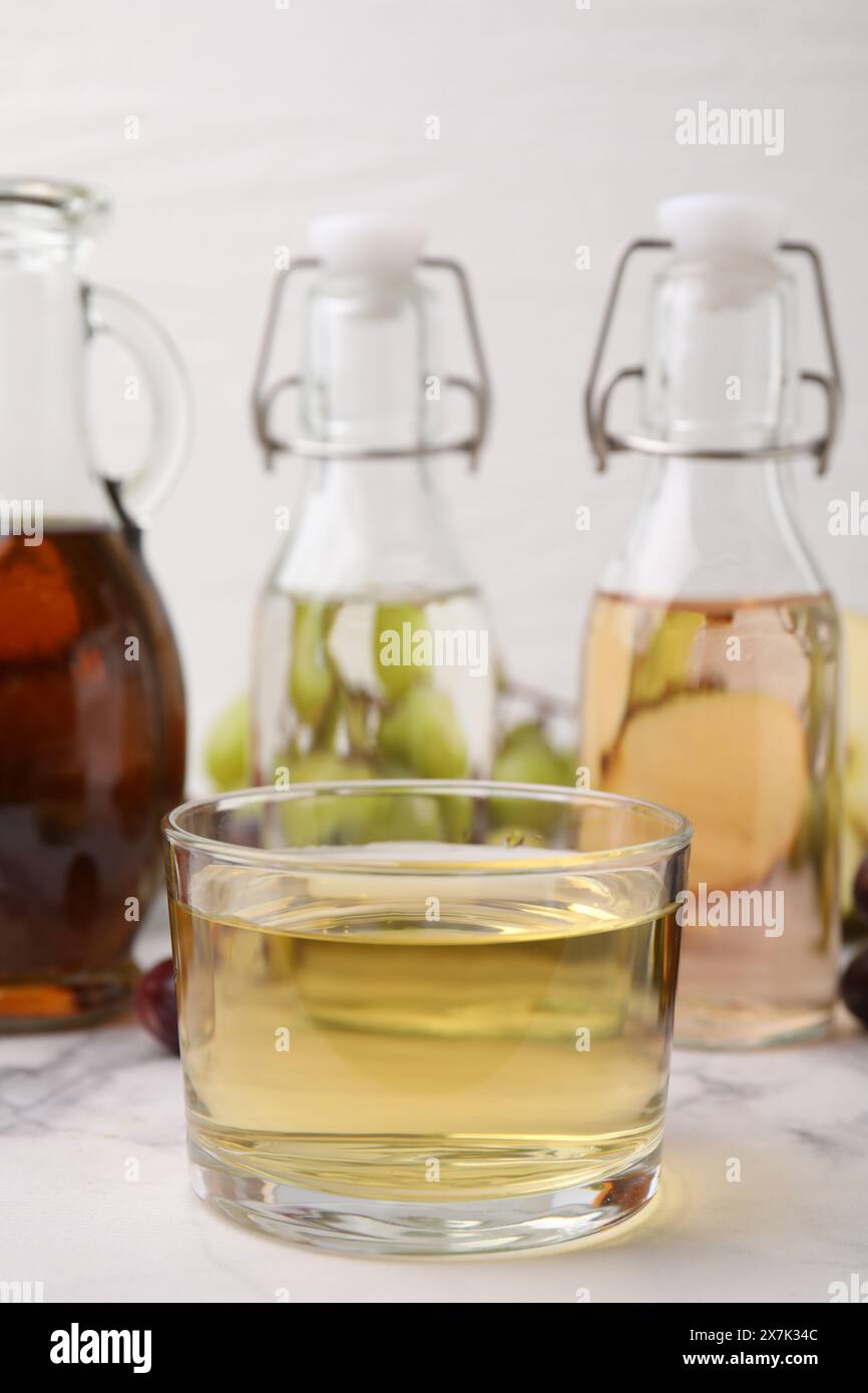 Different types of vinegar on light marble table, closeup Stock Photo ...
