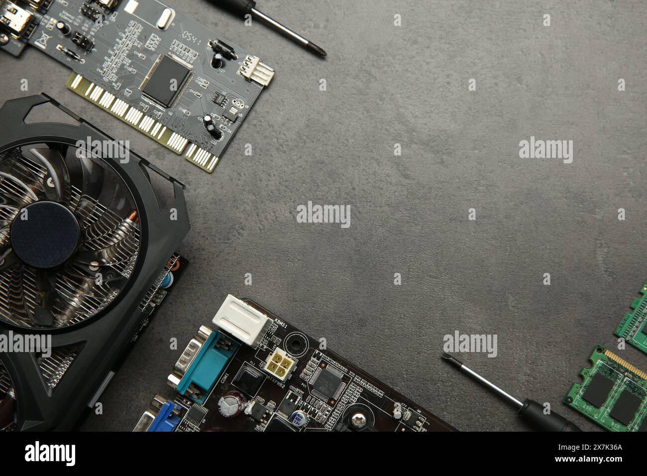 Graphics card and other computer hardware on grey textured table, flat ...
