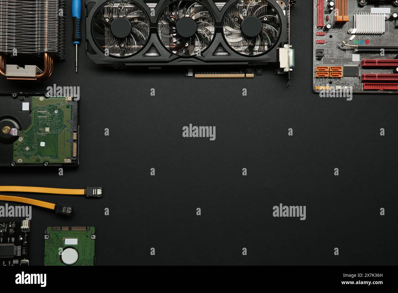 Graphics card and other computer hardware on black background, flat lay ...