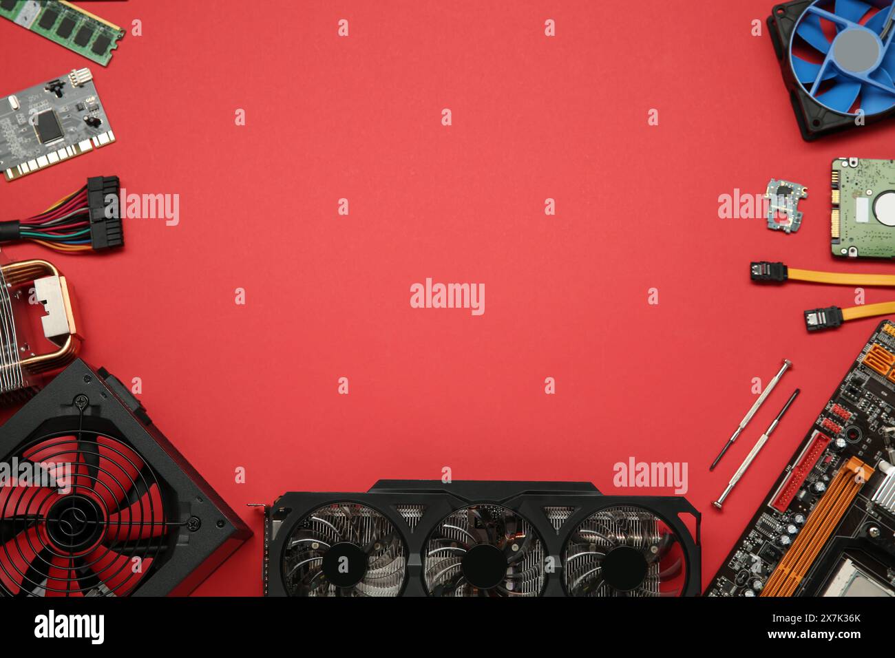 Graphics card and other computer hardware on red background, flat lay ...