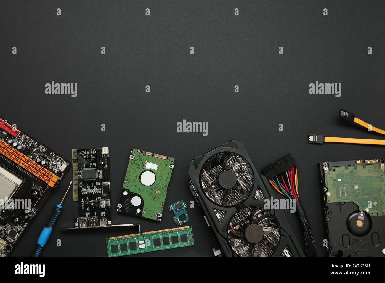 Graphics card and other computer hardware on black background, flat lay ...