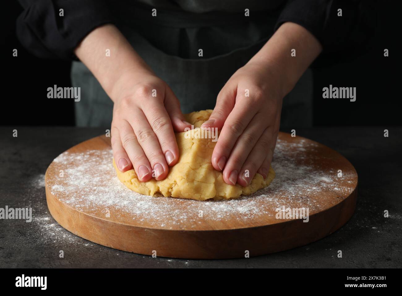 Making shortcrust pastry. Woman kneading dough at table, closeup Stock ...
