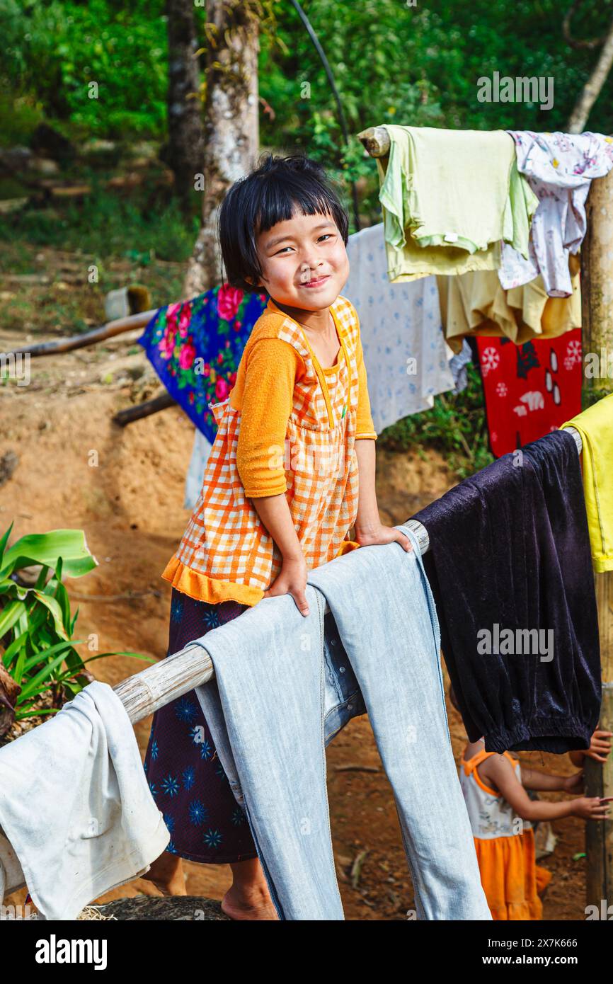 Happy Lahu children with laundry hanging up to dry in a village near ...