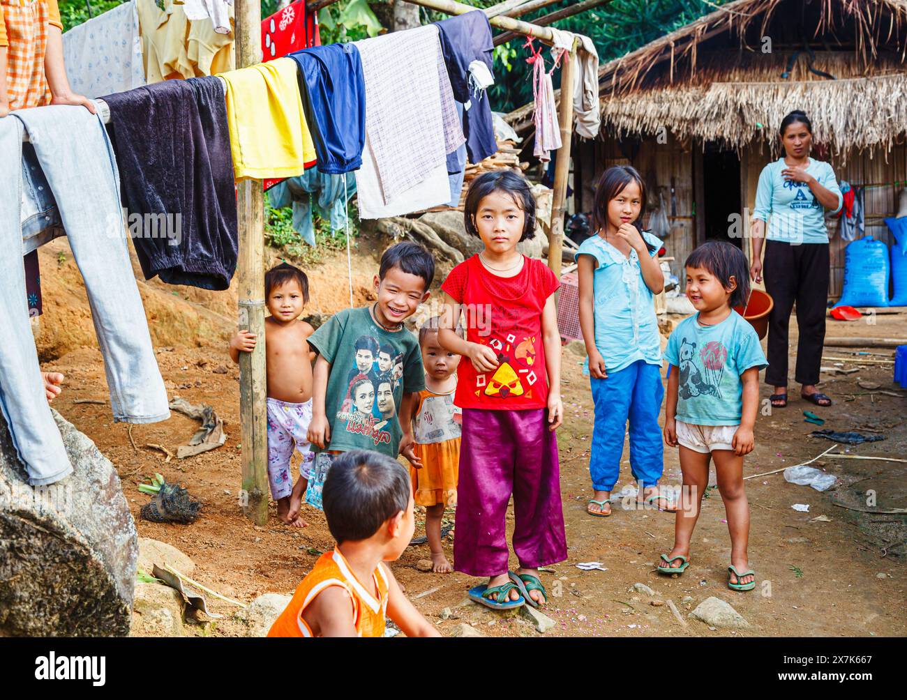 Happy Lahu children with laundry hanging up to dry in a village near ...