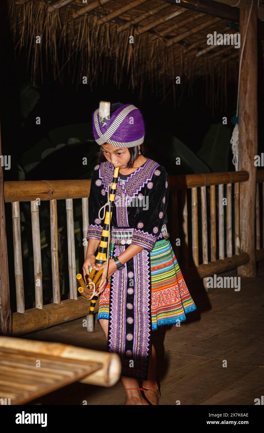 A Hmong young girl plays a musical instrument in Chiang Khong in Chiang ...
