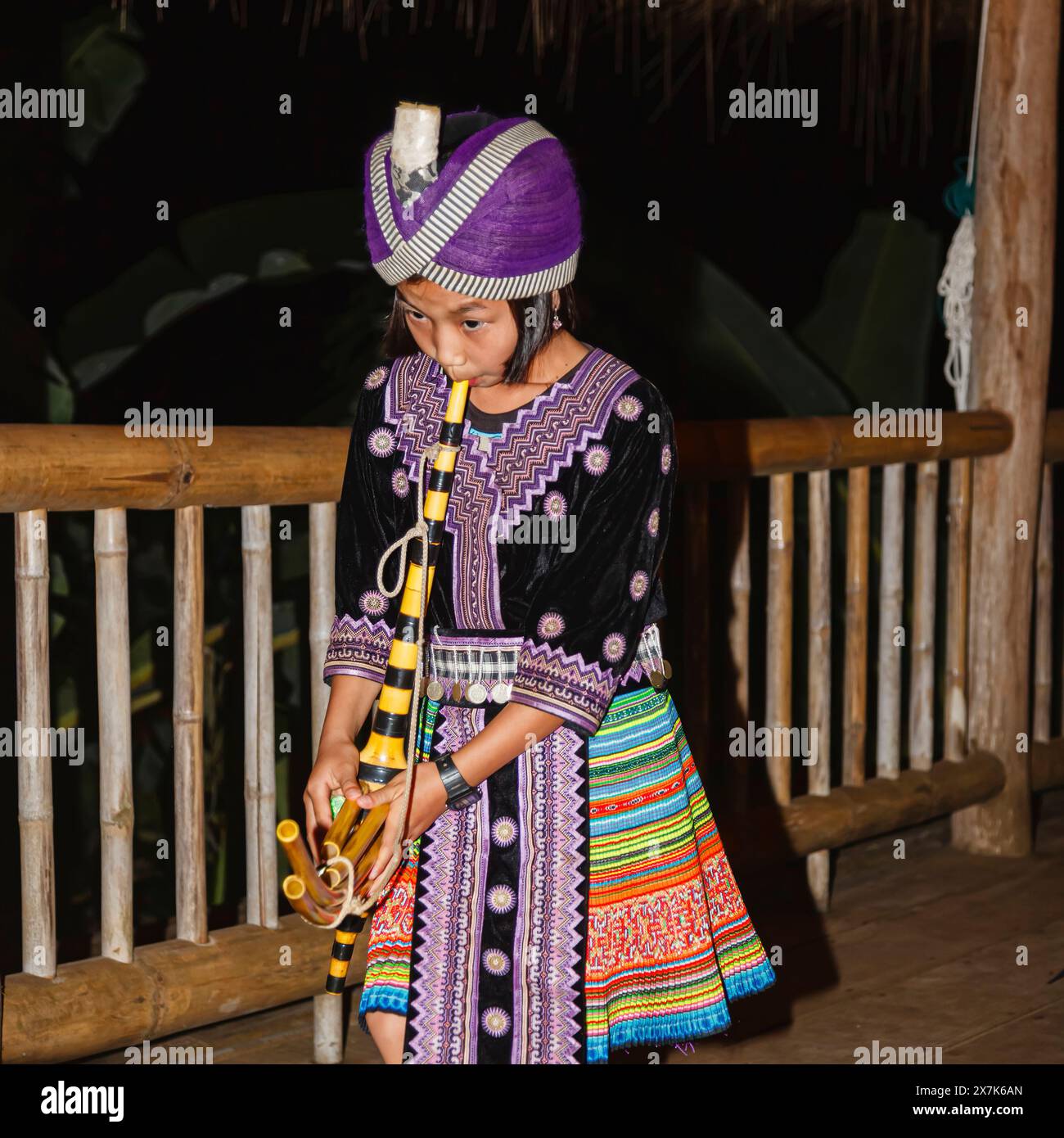 A Hmong young girl plays a musical instrument in Chiang Khong in Chiang ...