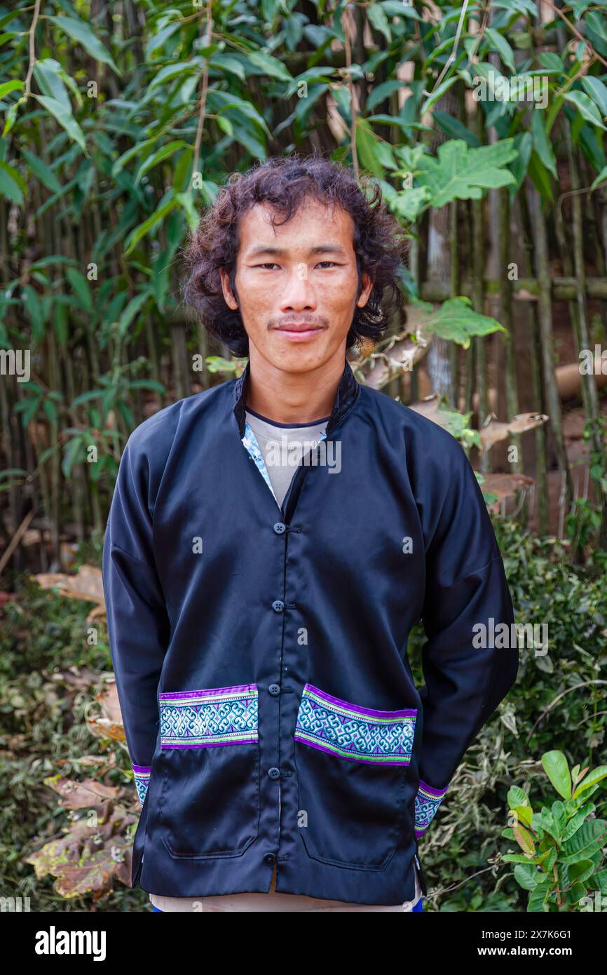 Portrait of a young man dressed in typical paj ntaub or flower cloth ...