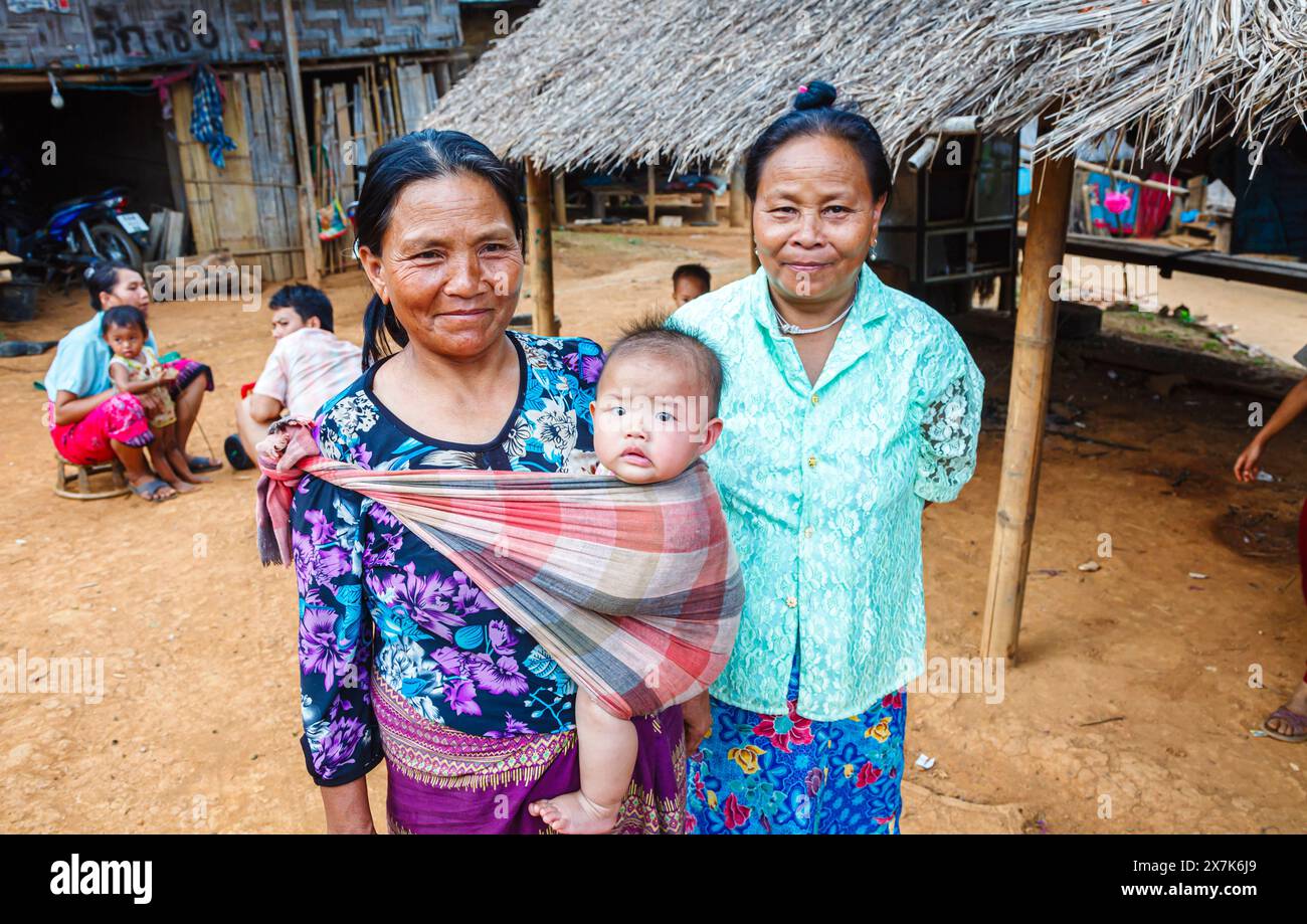 Lahu mother carries a baby child in a scarf sling at Ban Kiew Karn ...