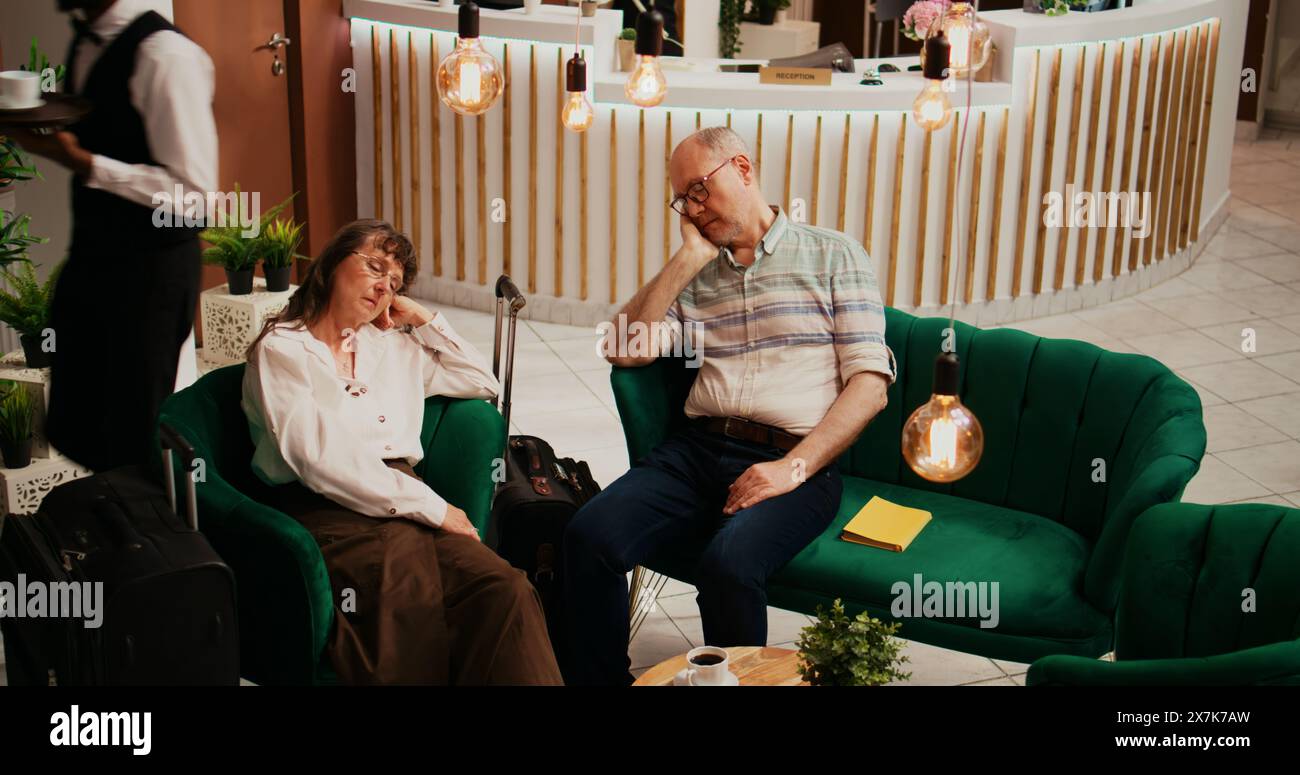 Tired old tourists falling asleep at hotel, feeling exhausted because ...